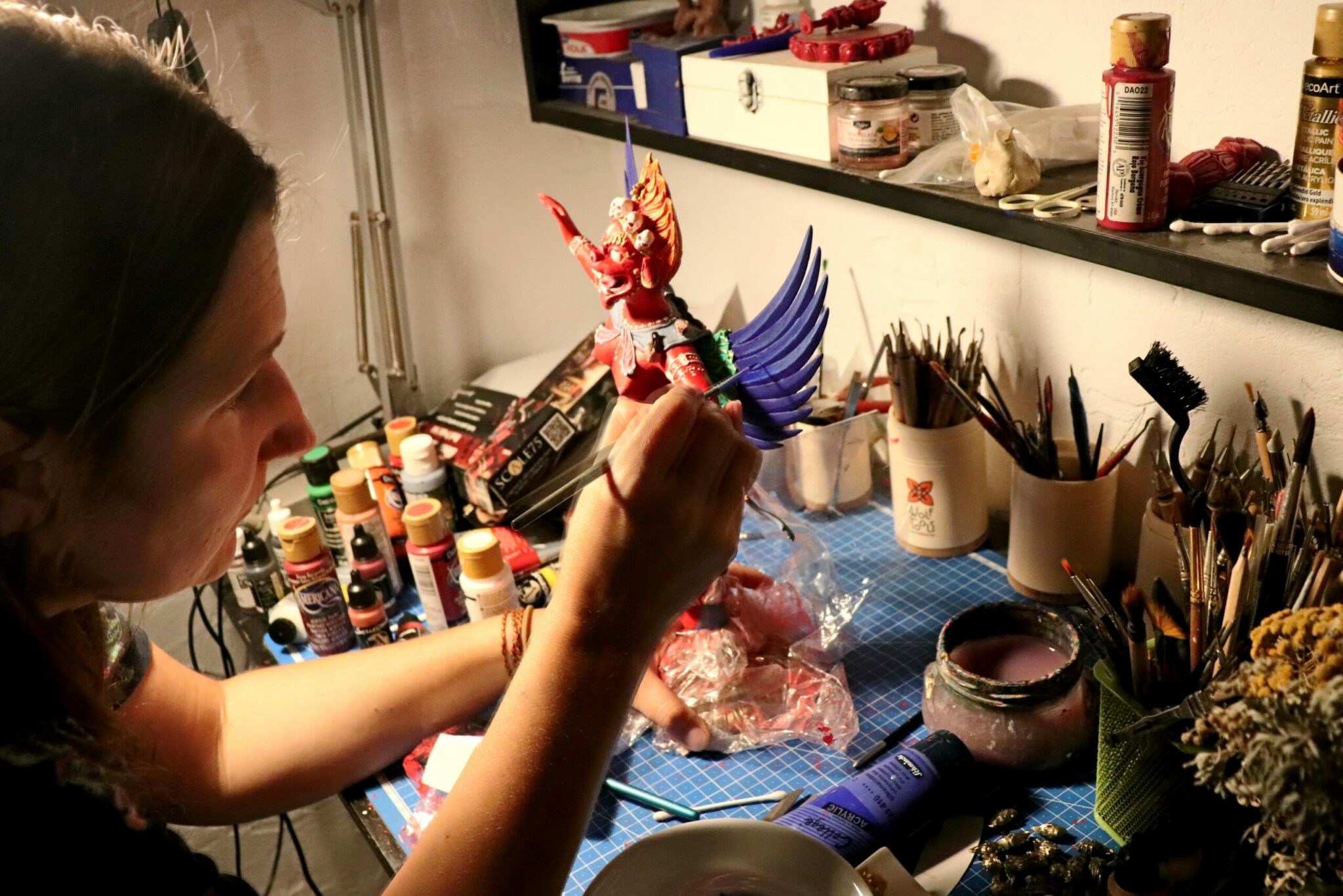 Painting the thankga art details on statue Simhamukha - Buddha Weekly ...